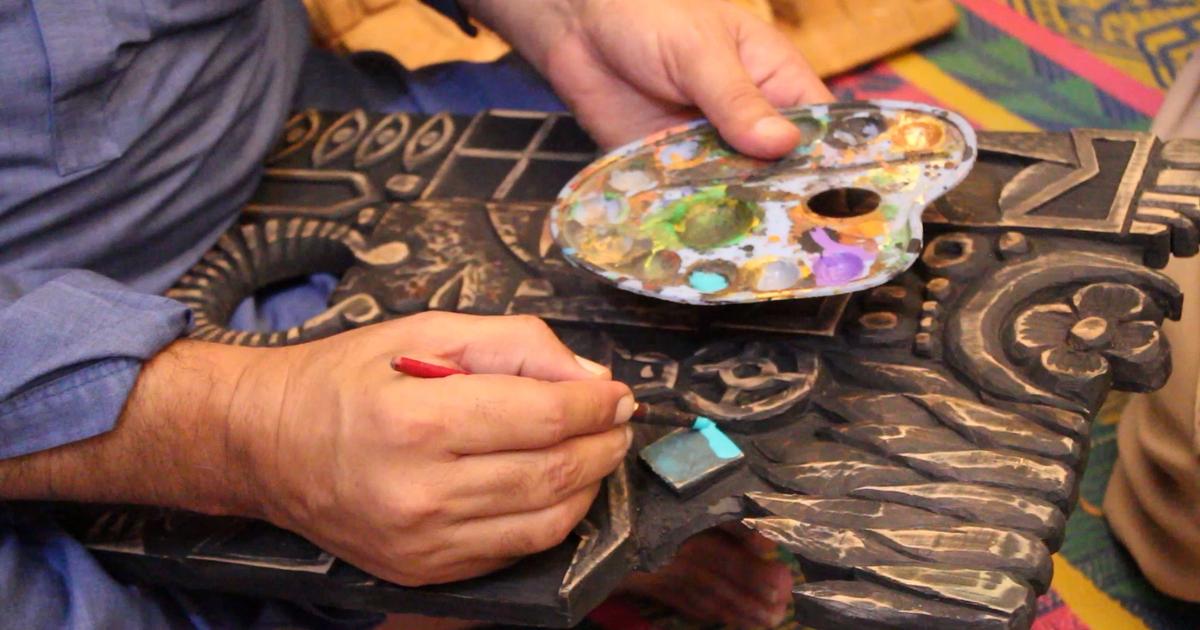 Calligraphers presenting Islamic calligraphy on panels through wooden ...